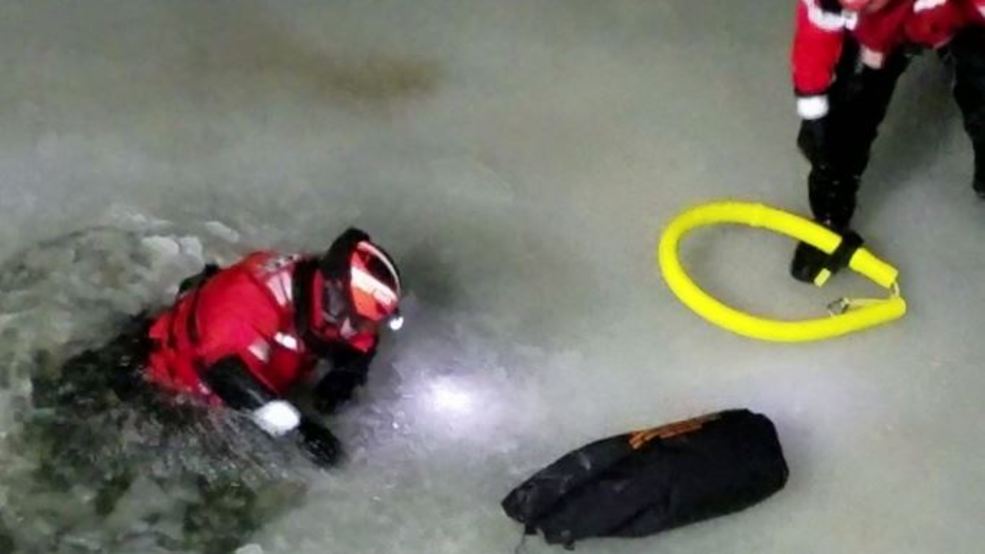 Coast Guard crewman goes through the ice during a rescue near ...